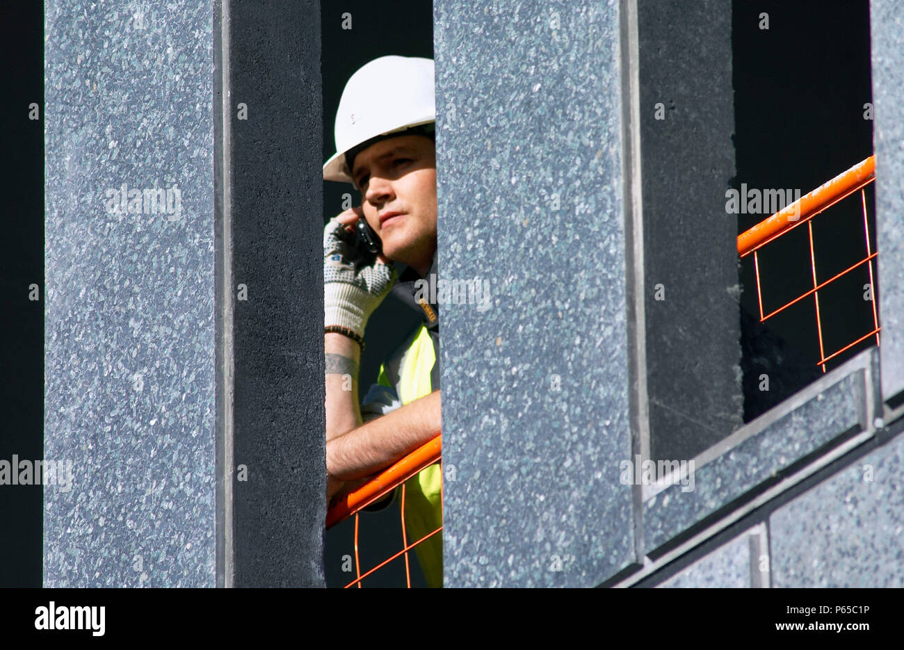 Construction worker using a mobile phone on site Stock Photo - Alamy