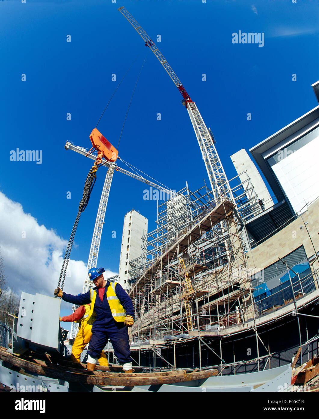 Crane delivery of building materials on a construction site Stock Photo ...