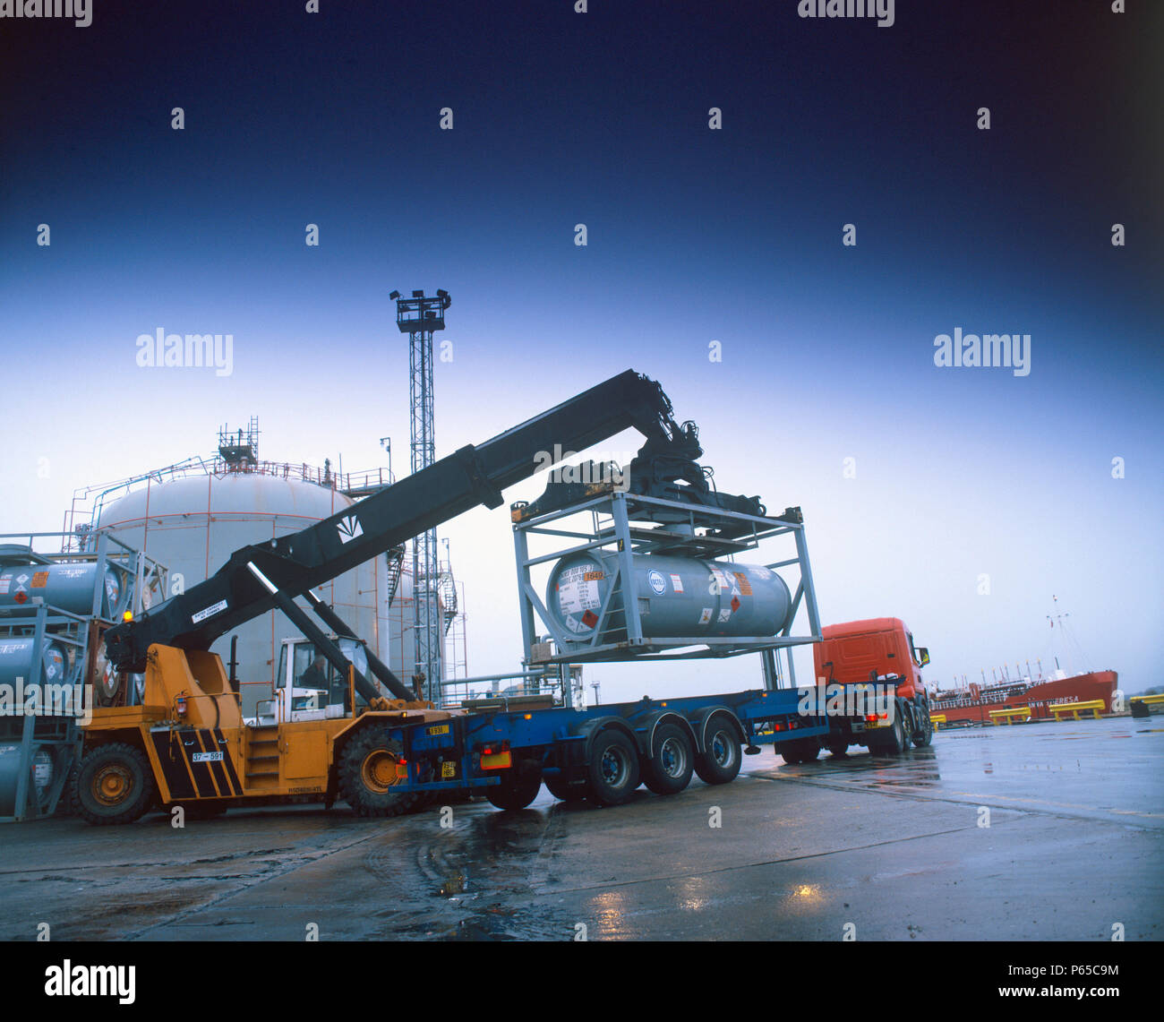 Telescopic forklift lifting a waste container on a truck Stock Photo ...