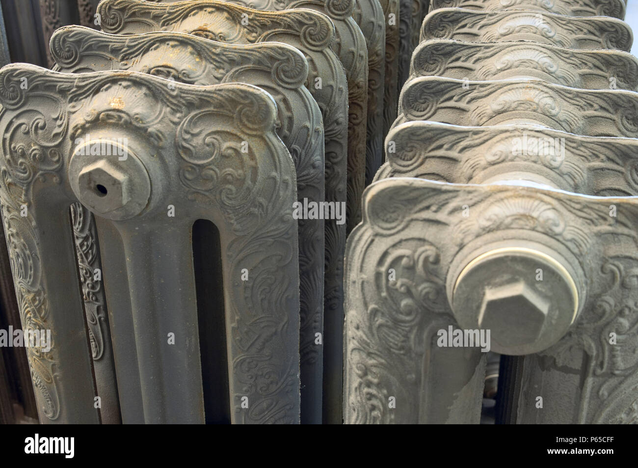 Cast iron radiators with Rococo style embossed decoration in salvage ...