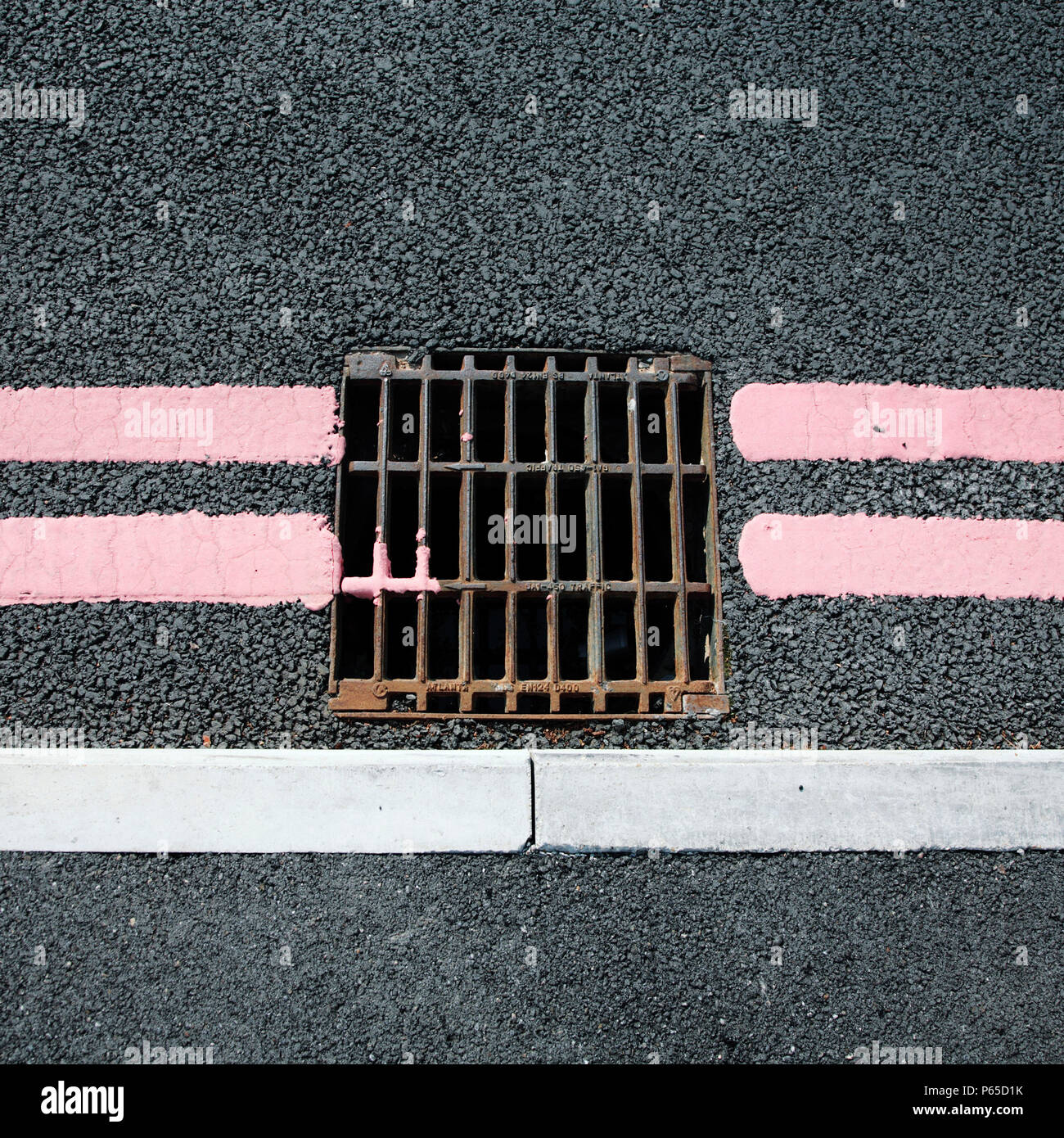 Kerbside, drain and double-red lines, UK Stock Photo - Alamy