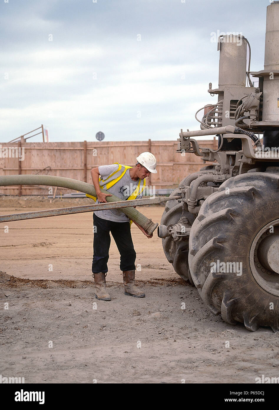 Operative attaching hose to pump Stock Photo - Alamy