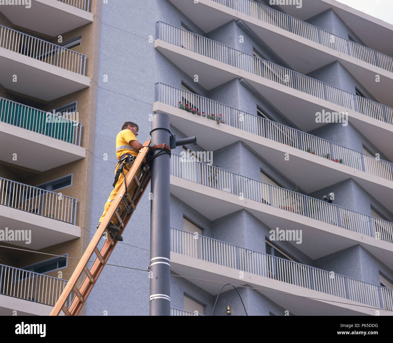 Worker preparing to install overhead power lines for new tram system ...