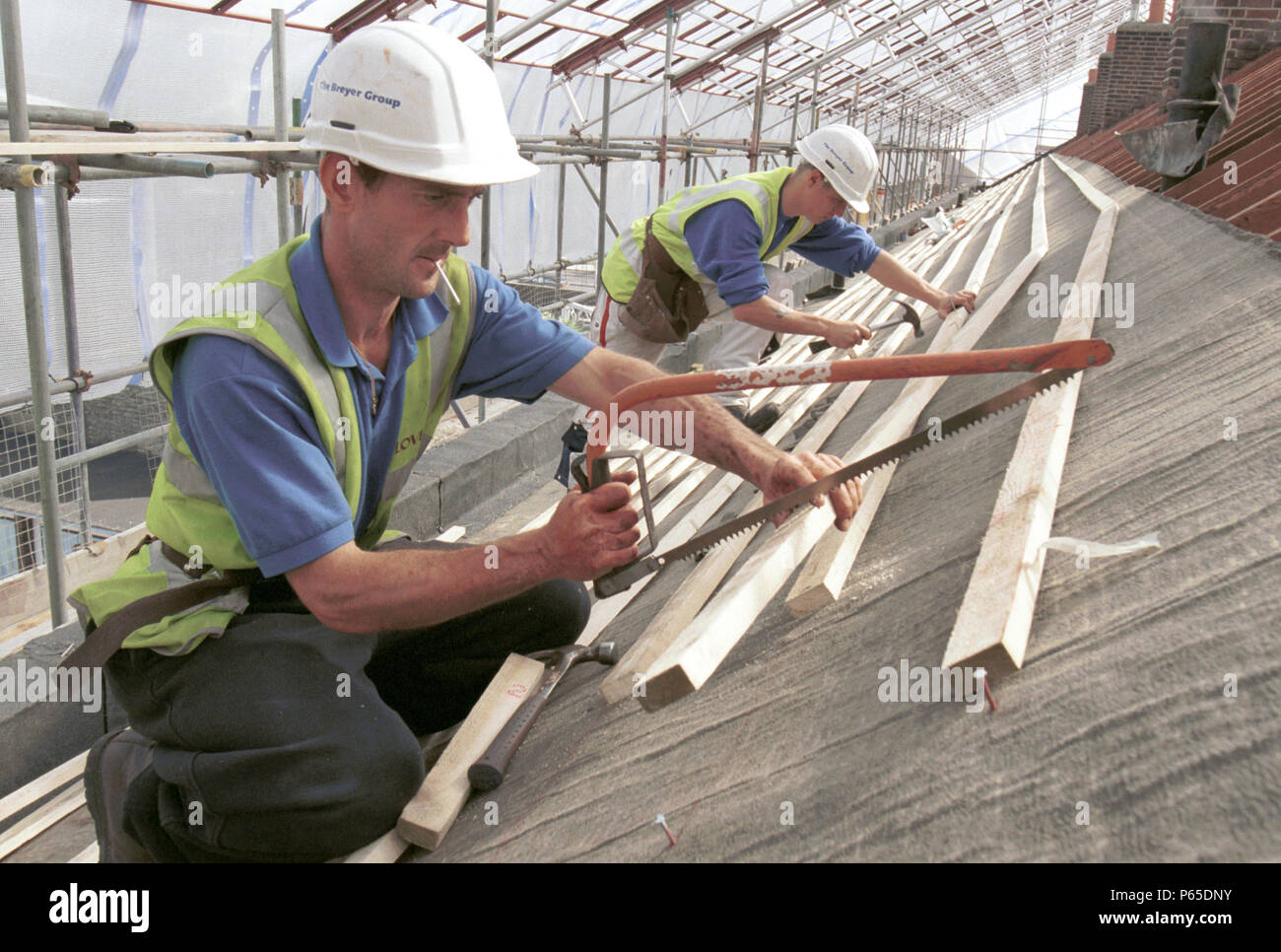 Roof Slating. Sawing and nailing battens on roof Stock Photo - Alamy