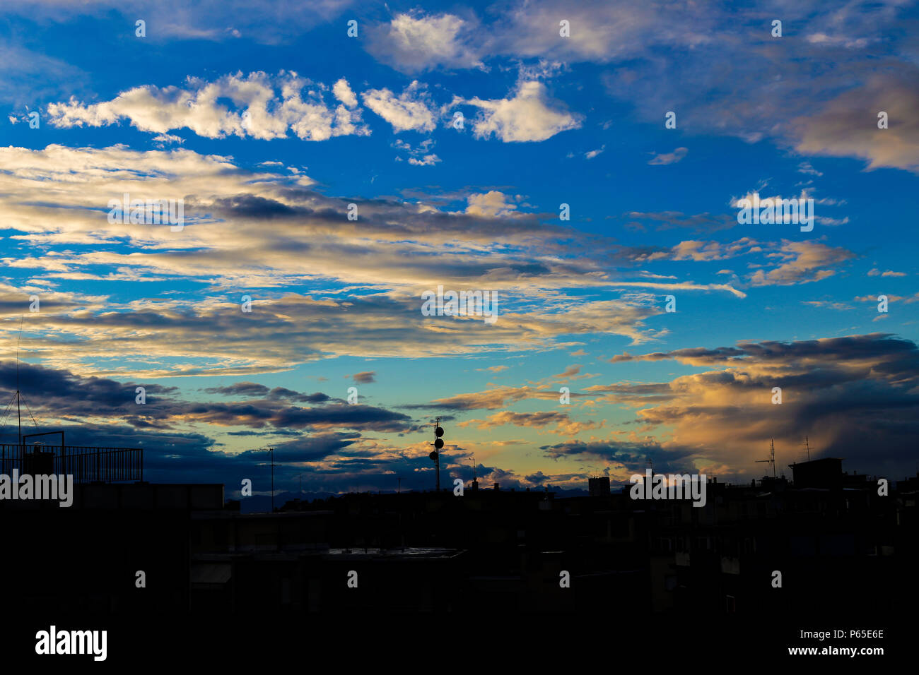 Evening city in sunset sky background Stock Photo - Alamy