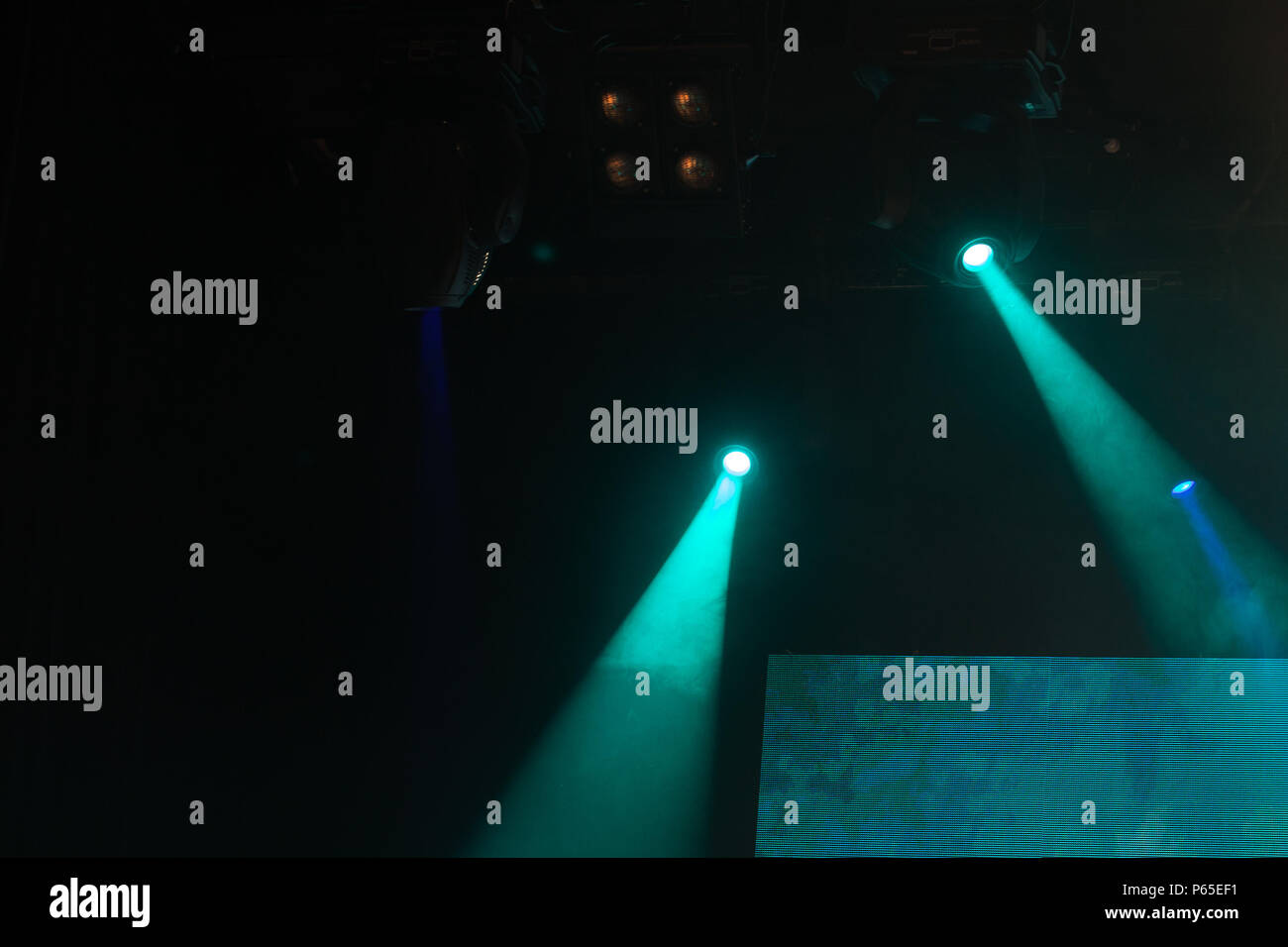 Cyan scenic spot lights, beams and smoke over dark background, modern ...