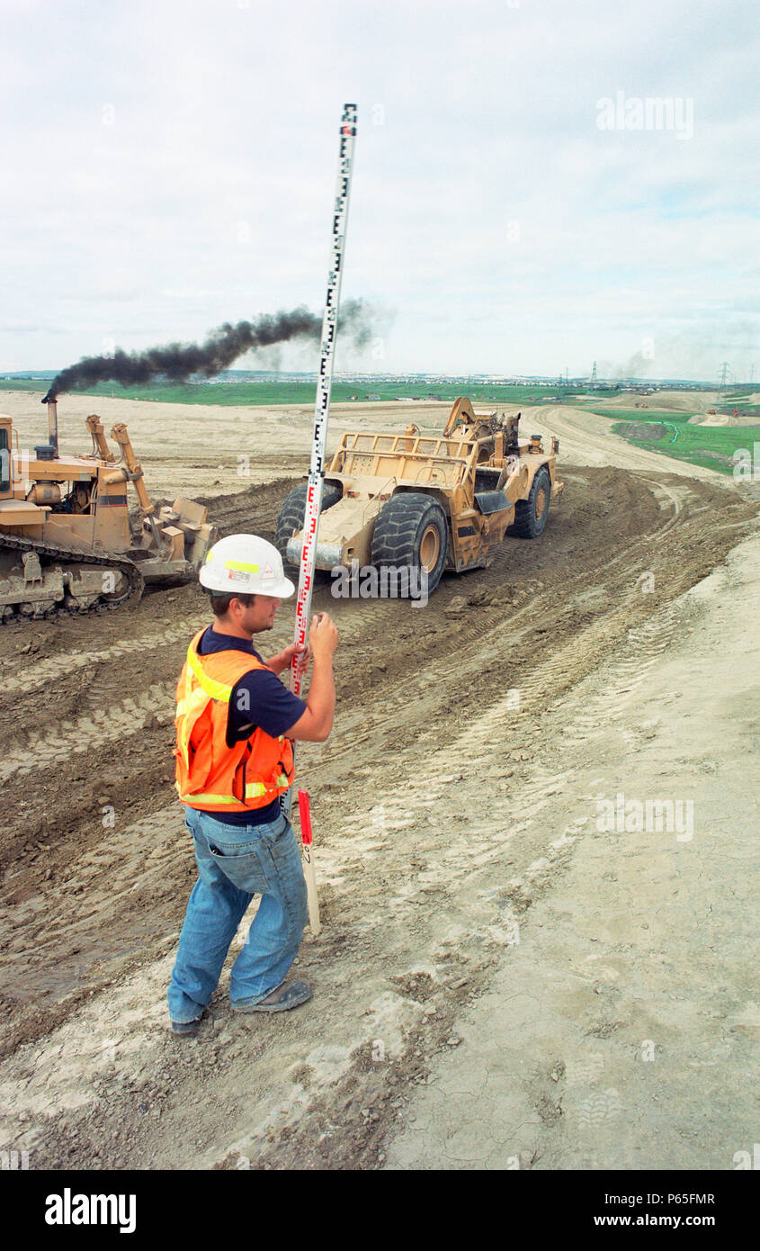 Setting out levels for the earthmoving Stock Photo - Alamy
