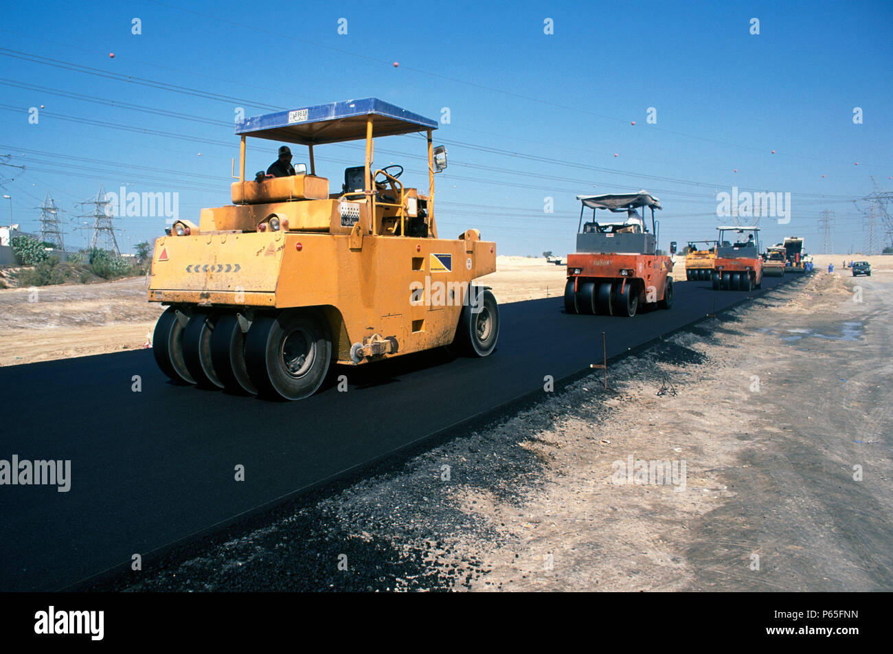 A squad of tyred rollers is used for the finishing work on the asphalt ...