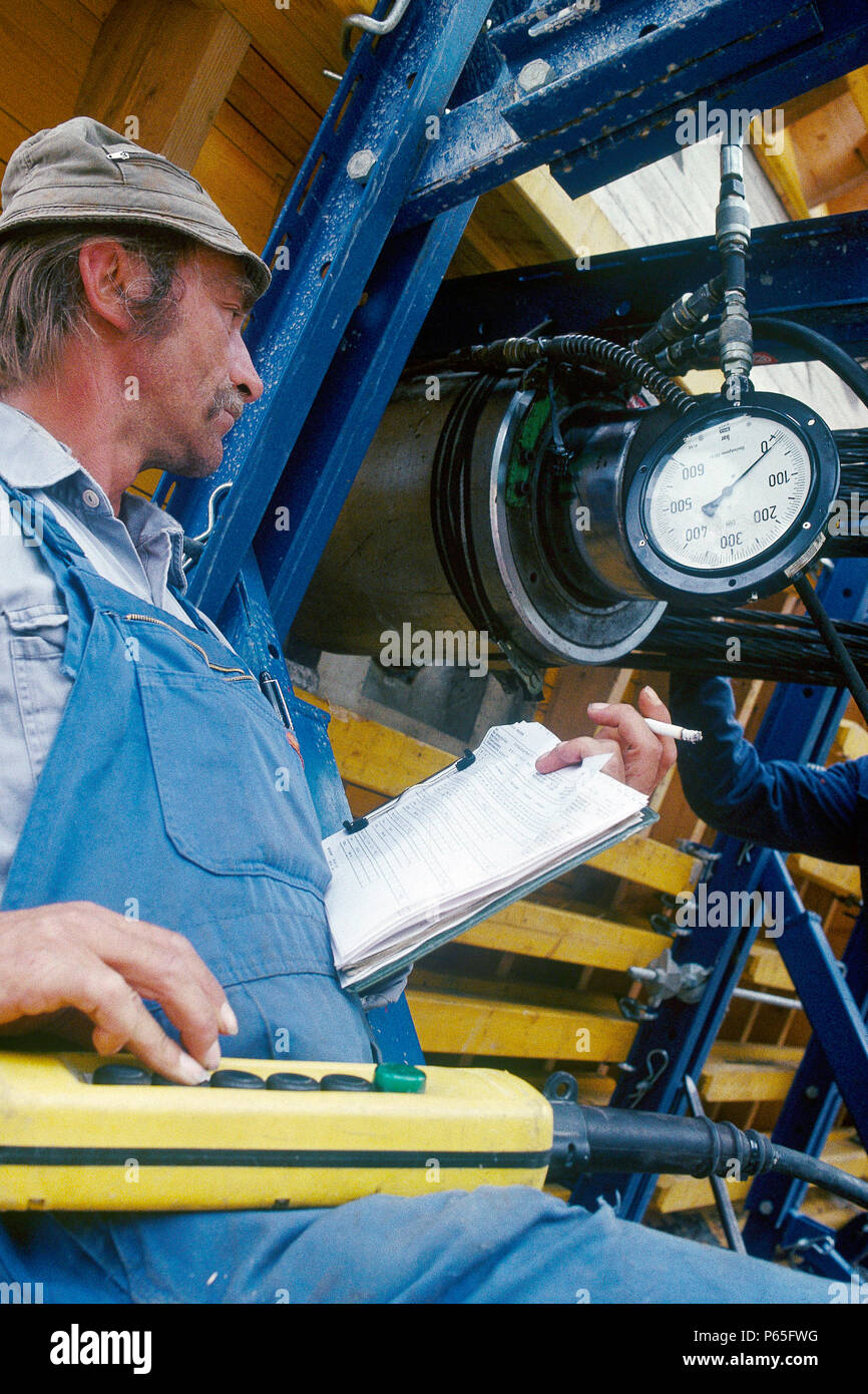 Prestressing and tensioning cable strands during bridge construction ...