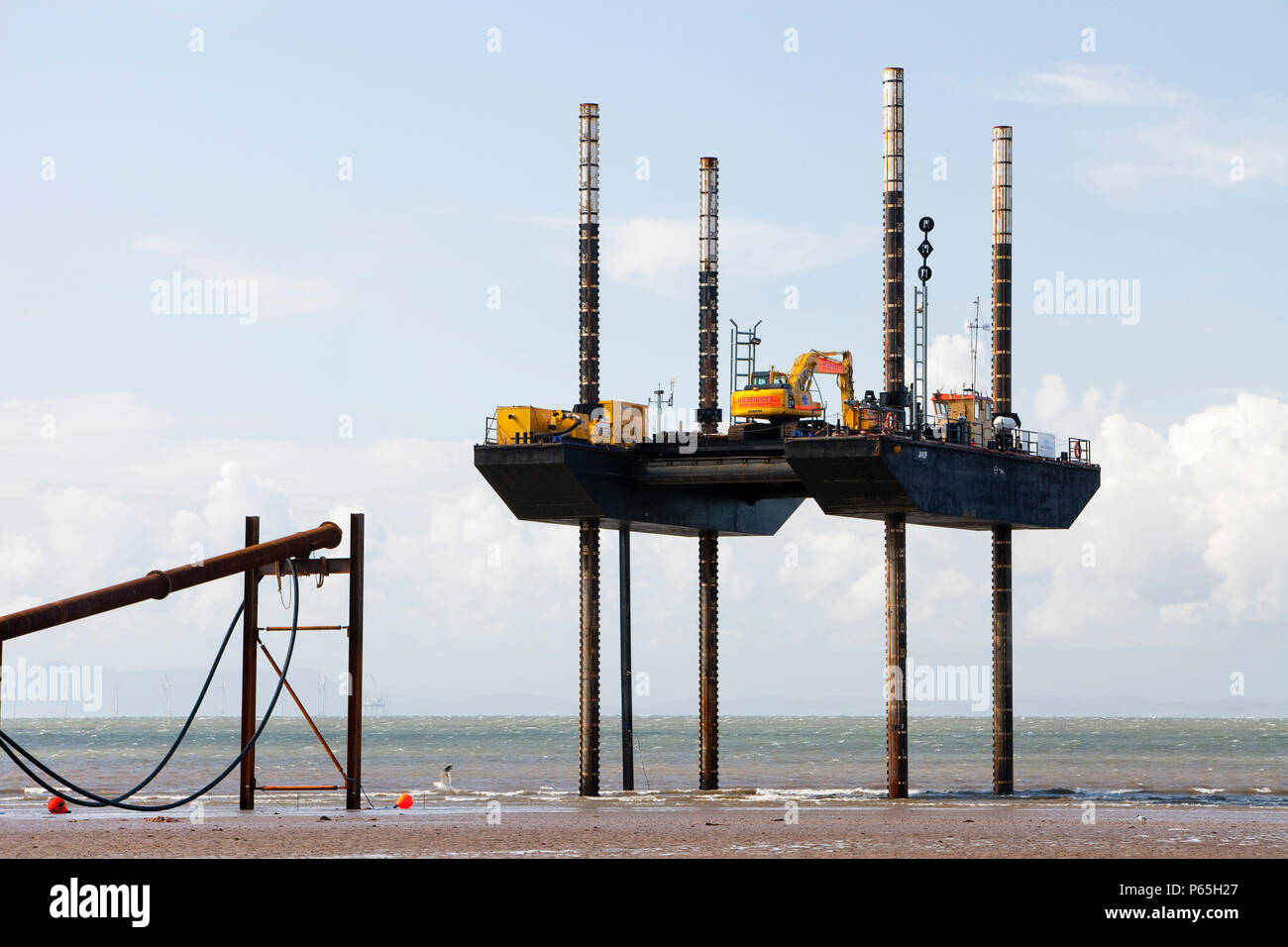 A jack up barge working on the foreshore of the Solway Firth near Workington, installing the ...