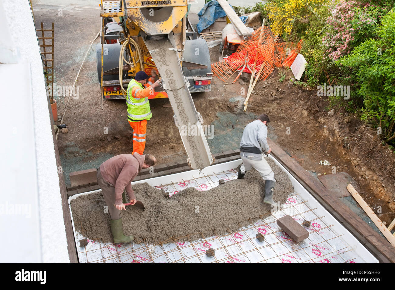 Pouring concrete for the floor of a house extension, Ambleside, UK ...