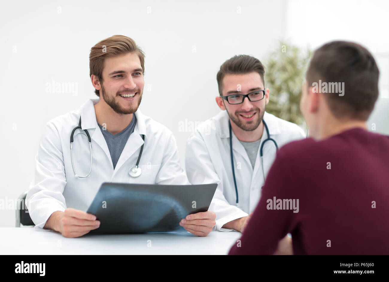 group of doctors welcoming their customer with a handshake Stock Photo ...