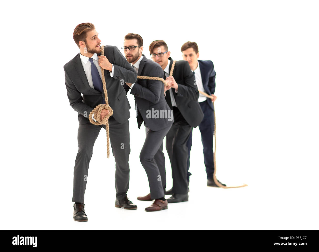 closeup.smiling business team pulls the rope Stock Photo - Alamy