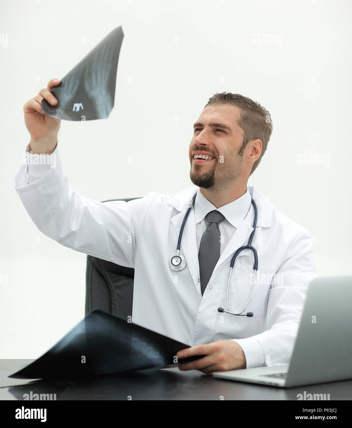 doctor examines an x-ray,sitting behind a Desk Stock Photo - Alamy