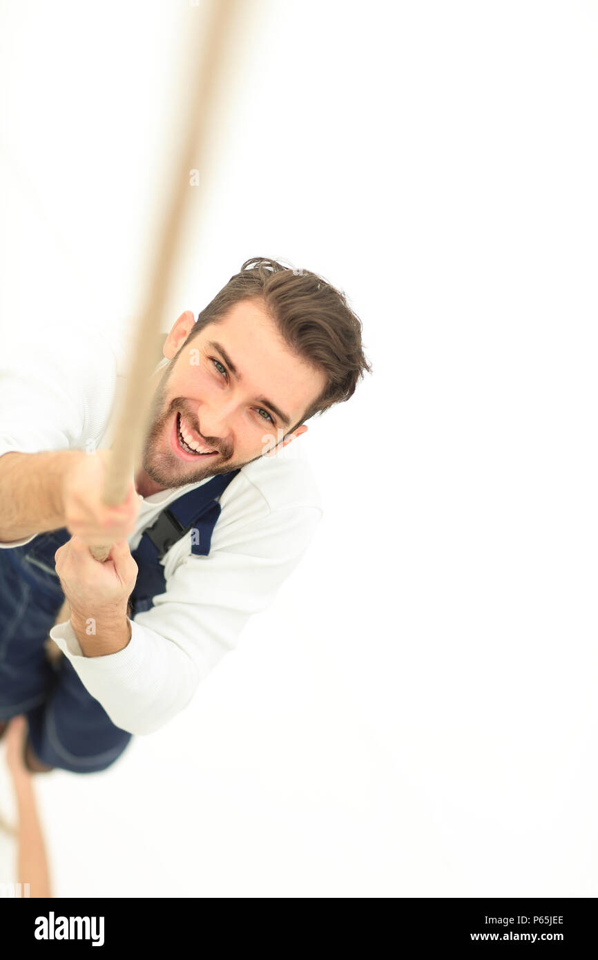 construction worker climbing the rope up Stock Photo - Alamy