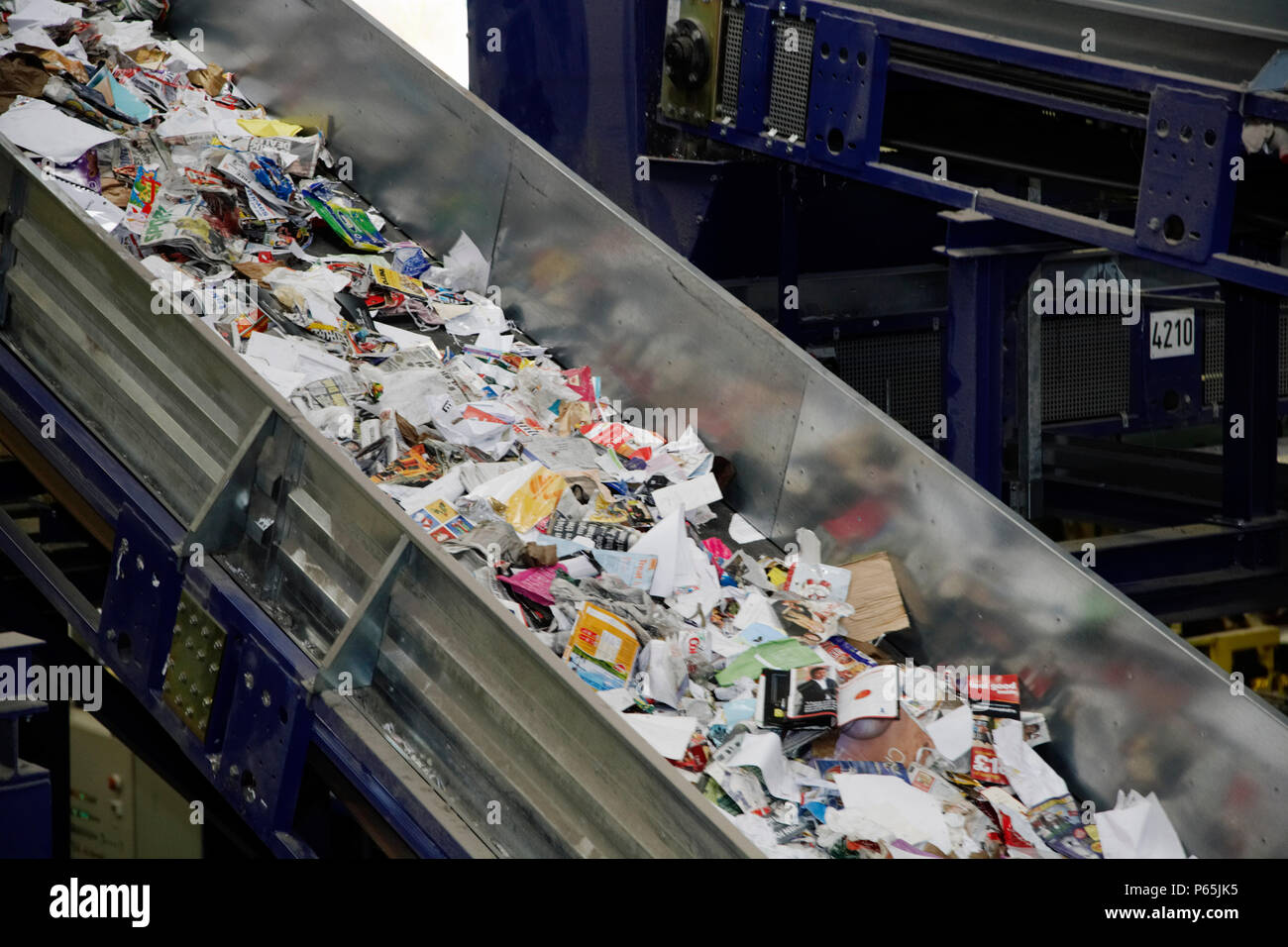Paper packaging recycling going down conveyor belt Stock Photo - Alamy