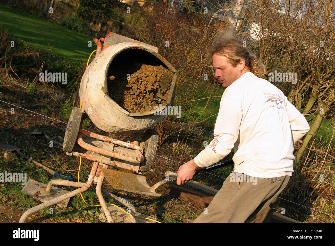 Man shoveling cement hi-res stock photography and images - Alamy