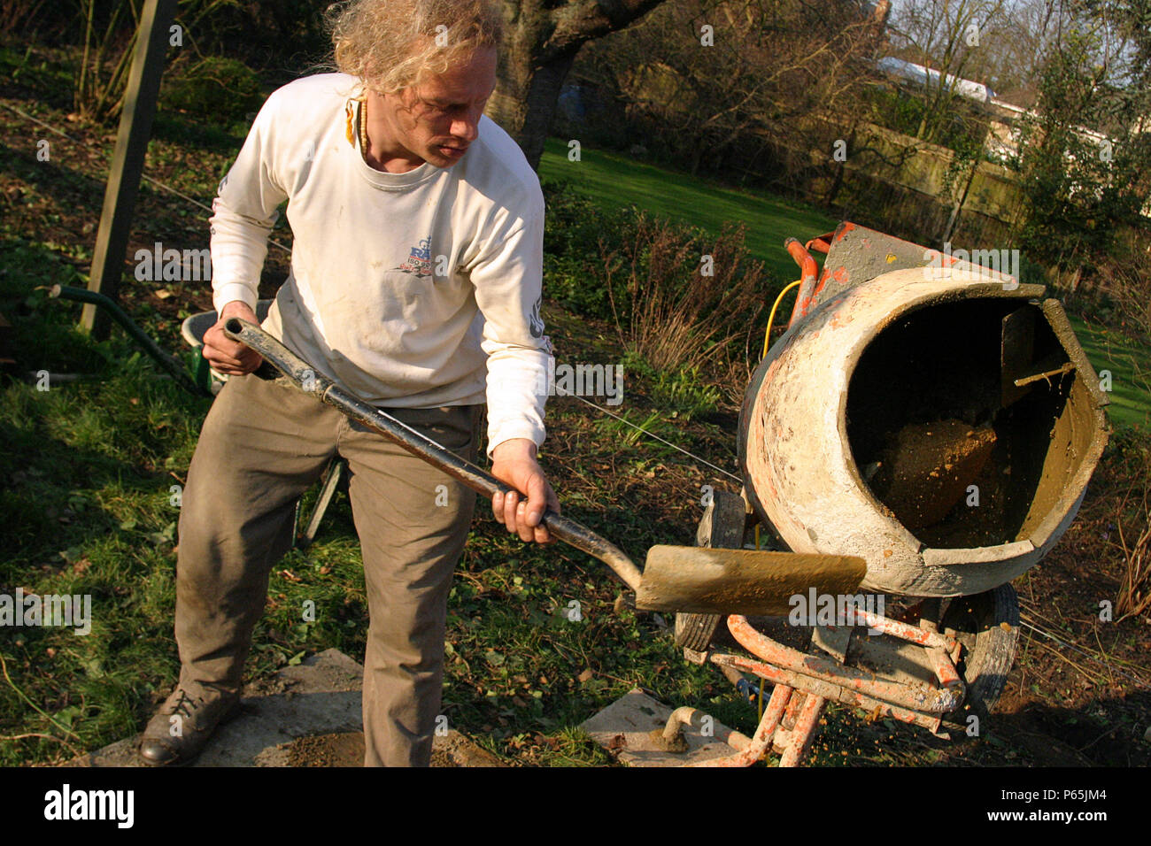 Man shoveling cement hi-res stock photography and images - Alamy