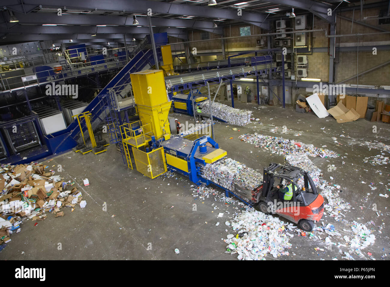 Forklift truck carrying compacted recycling Stock Photo - Alamy