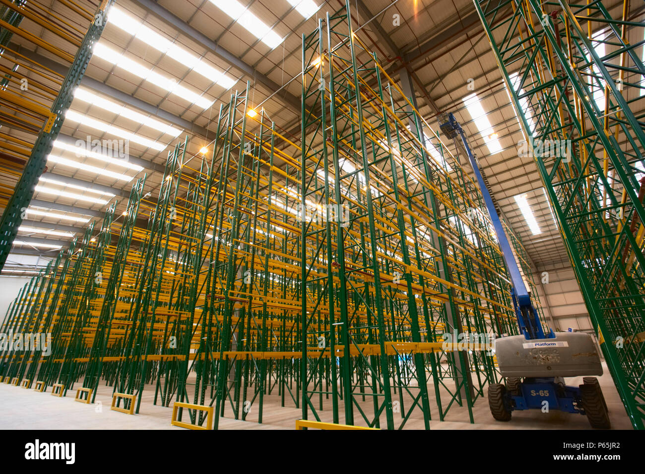Empty warehouse with shelving and racks Stock Photo - Alamy