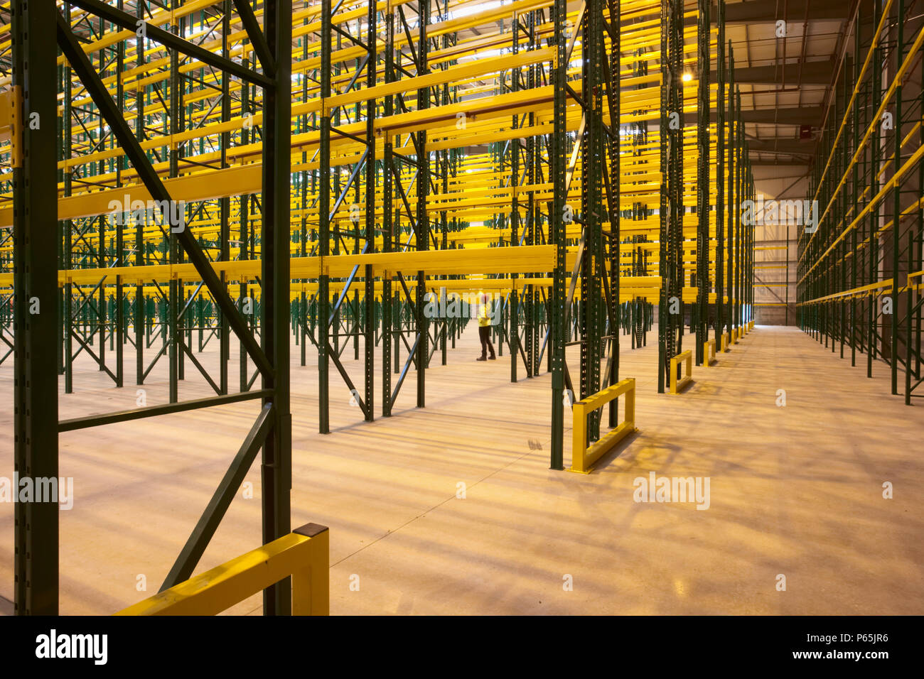 Empty warehouse with shelving and racks Stock Photo - Alamy
