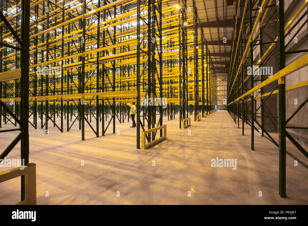 Empty warehouse with shelving and racks Stock Photo - Alamy
