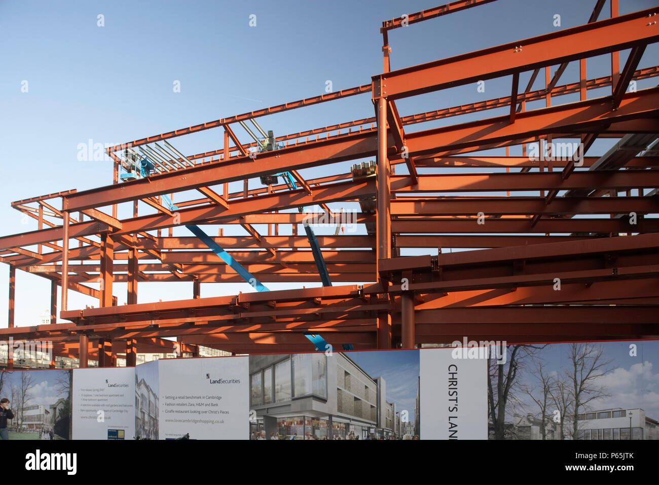 Construction workers on lift platform fixing steel girders Stock Photo ...