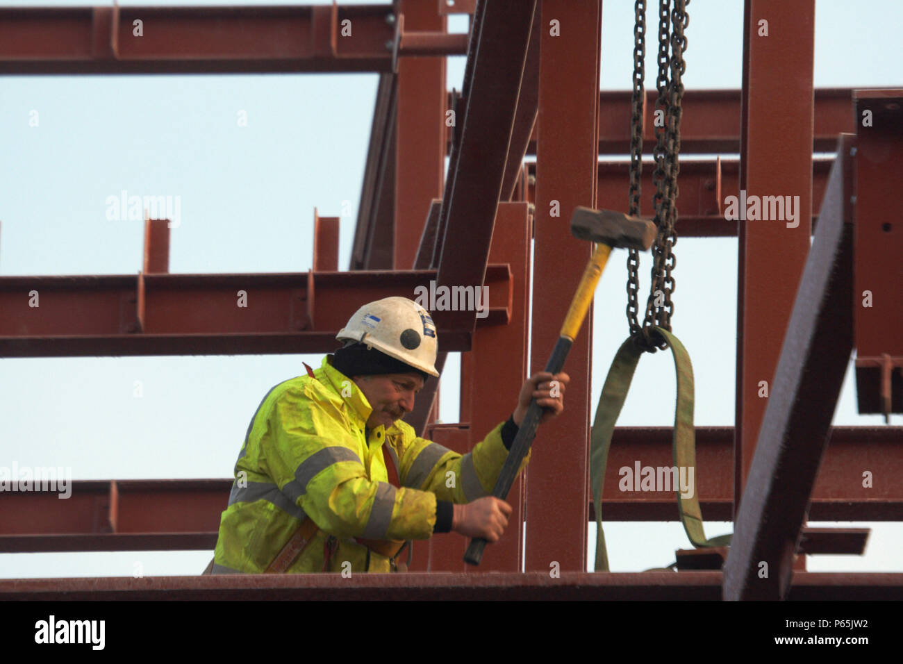 Construction worker working on a steel frame building Stock Photo - Alamy