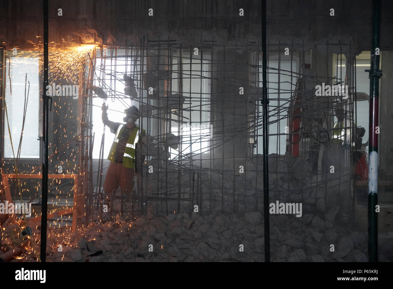 Cutting through reinforced steel bar during demolition of former stock ...