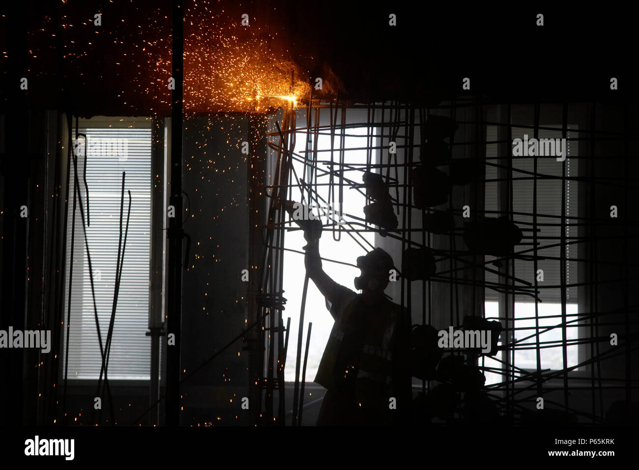 Cutting through reinforced steel bar during demolition of former stock ...