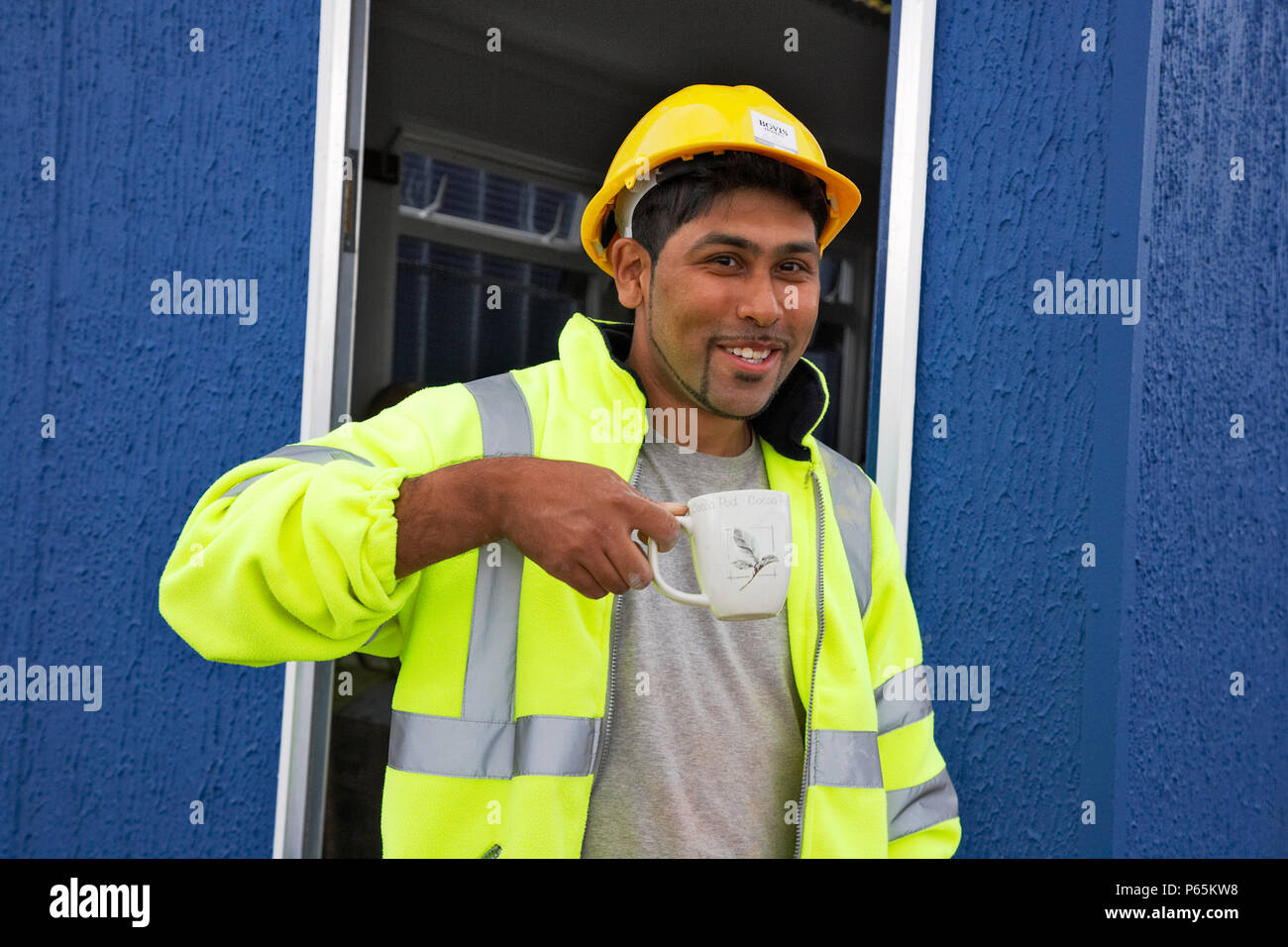 Construction worker having a cup of tea on a building site, England, UK ...
