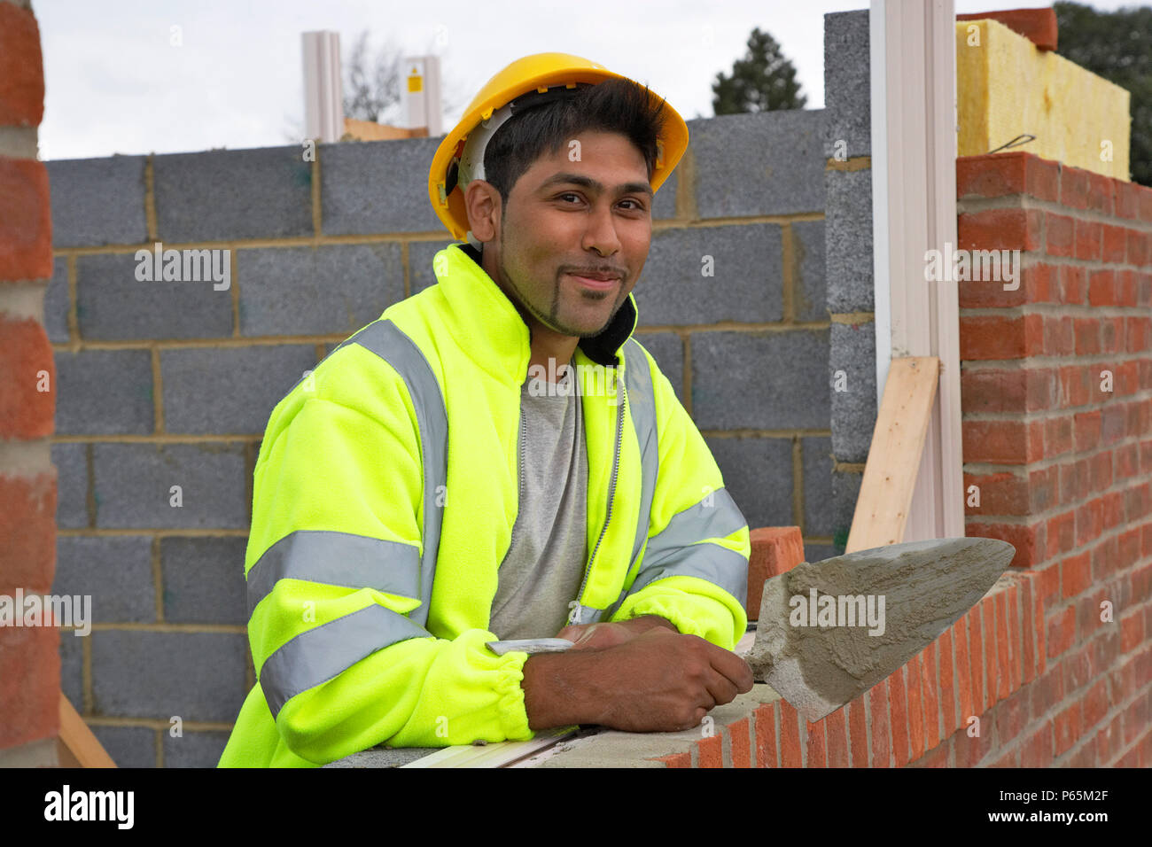Bricklayer with trowel on a house building site, England, UK Stock ...