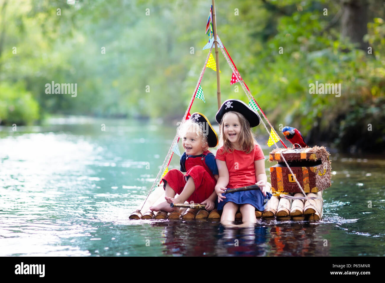 Kids dressed in pirate costumes and hats with treasure chest ...