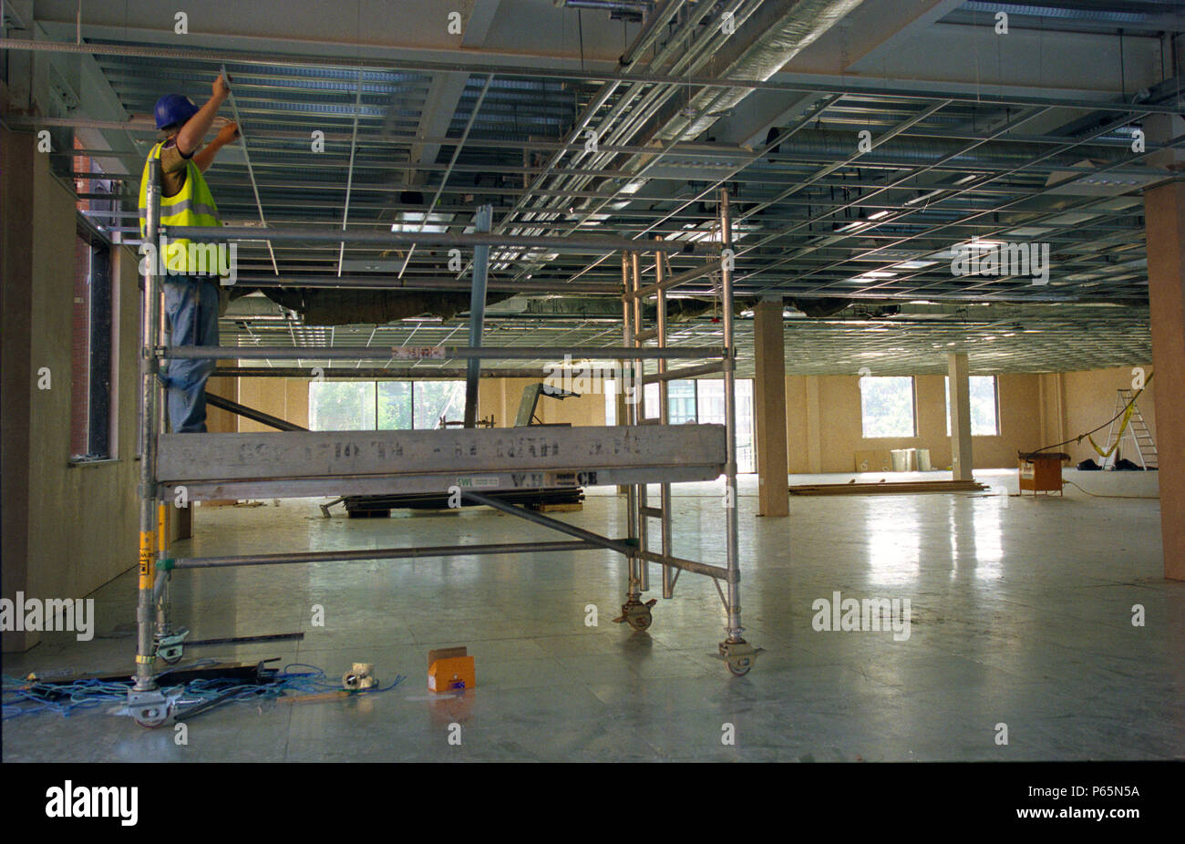 Builder positioning ceiling frame Stock Photo - Alamy