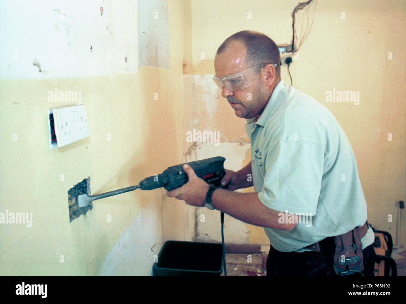 Kitchen Installation. Chasing out the wall for an electric socket Stock ...