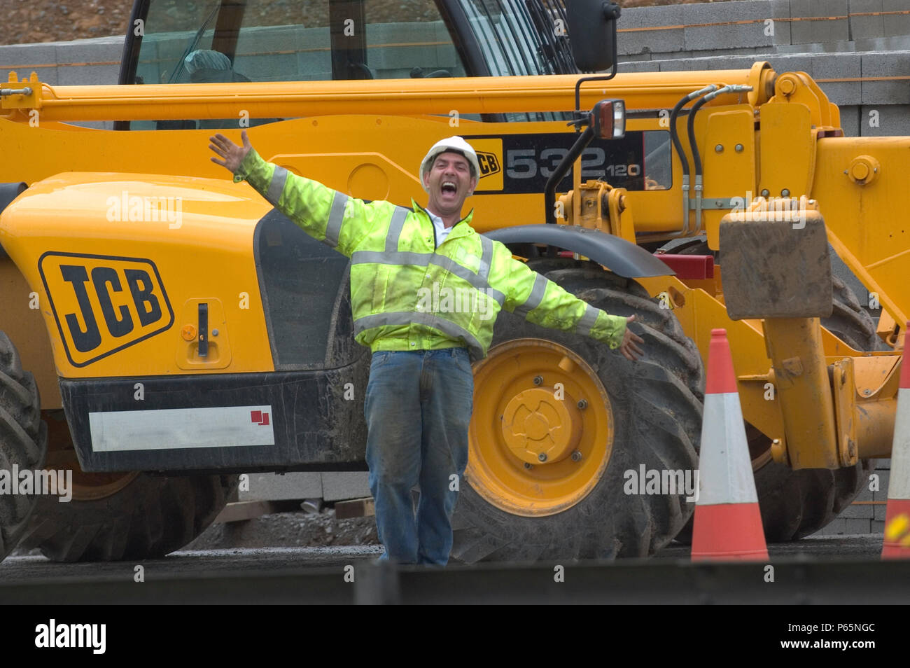 Happy construction worker on a construction site Stock Photo - Alamy