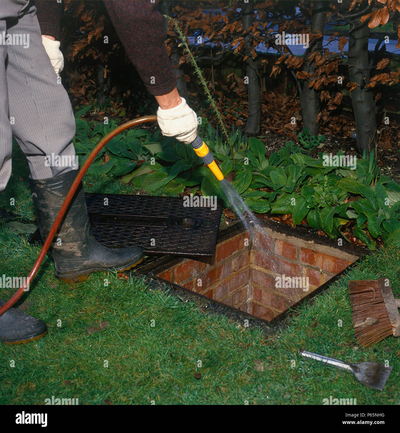 Cleaning manhole, domestic drain Stock Photo - Alamy