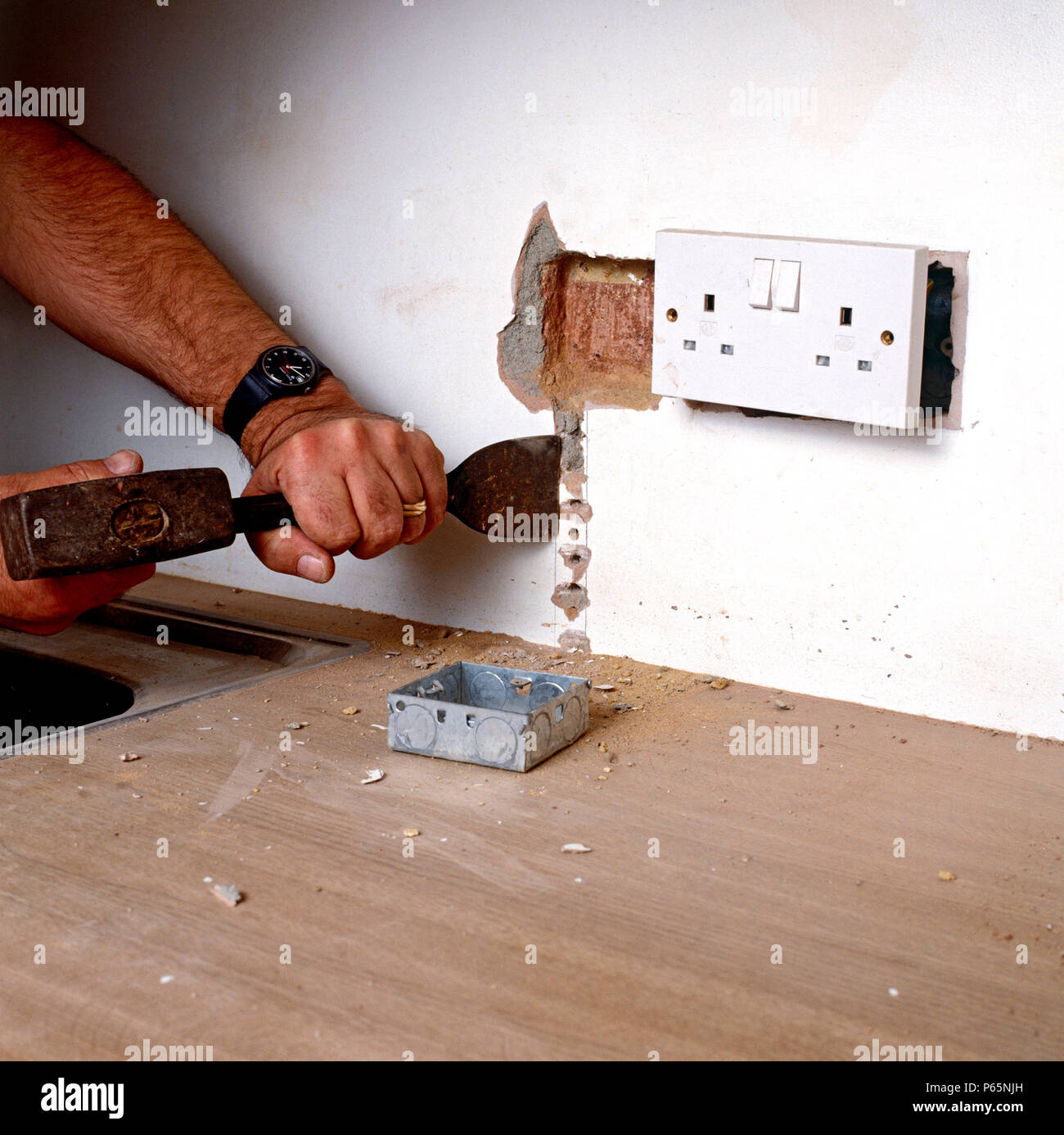 A new plug socket chased into a wall Stock Photo - Alamy