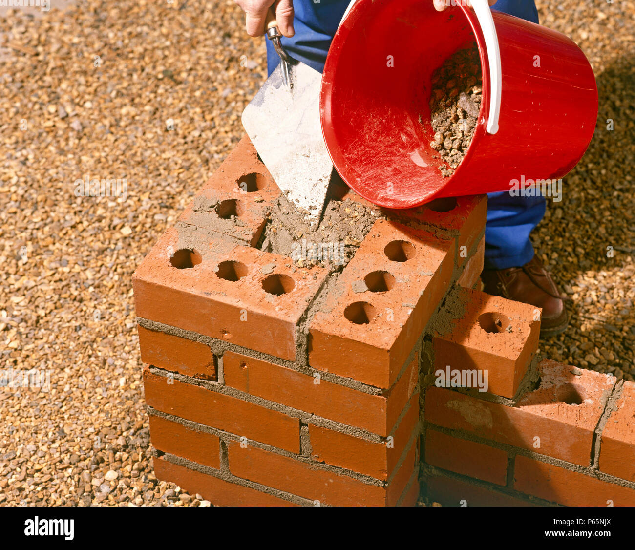 Bricklayer building a Brickwall Stock Photo - Alamy