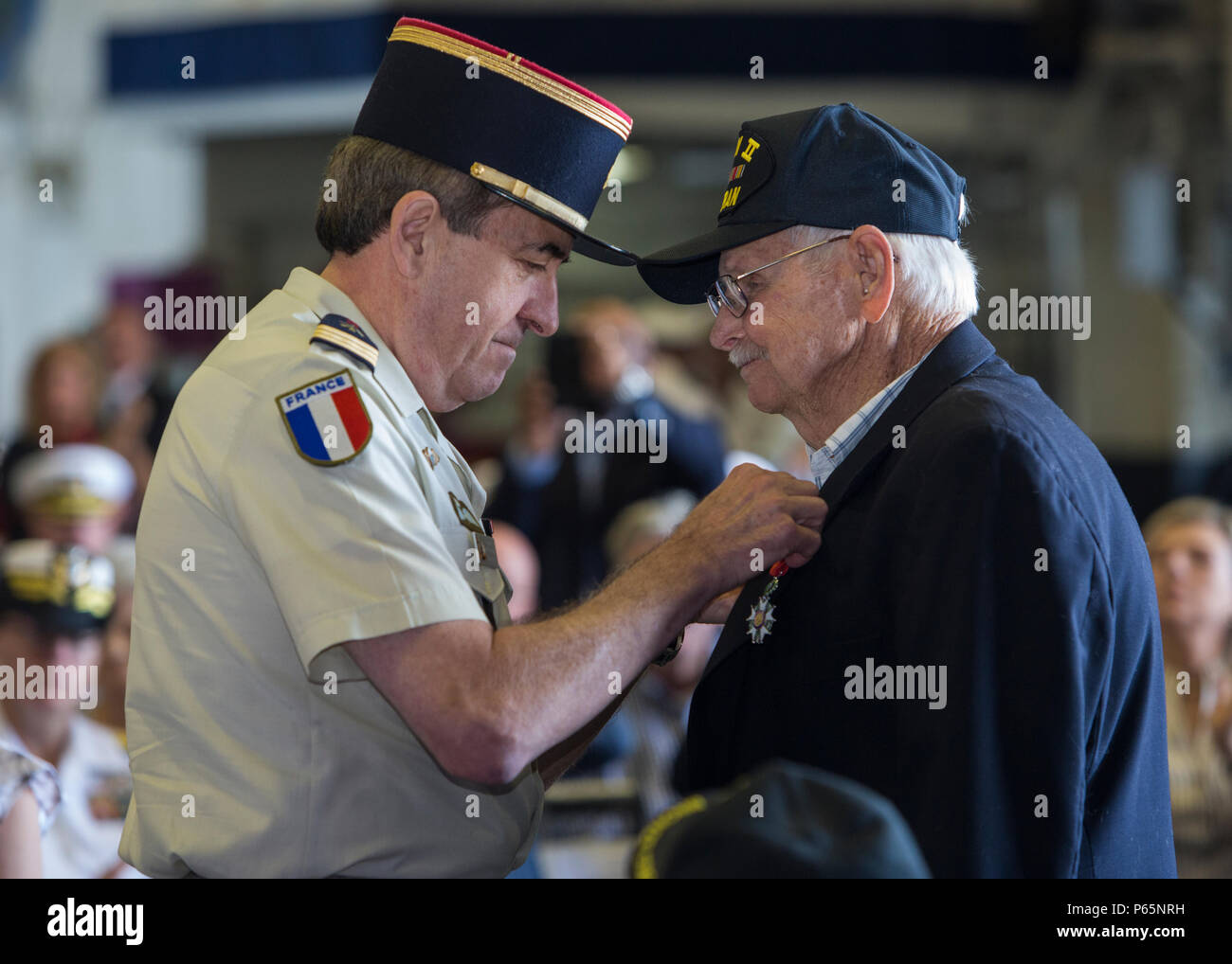 Capt. Jean-Michel Caffin of the French Army Reserve pins the Legion of ...
