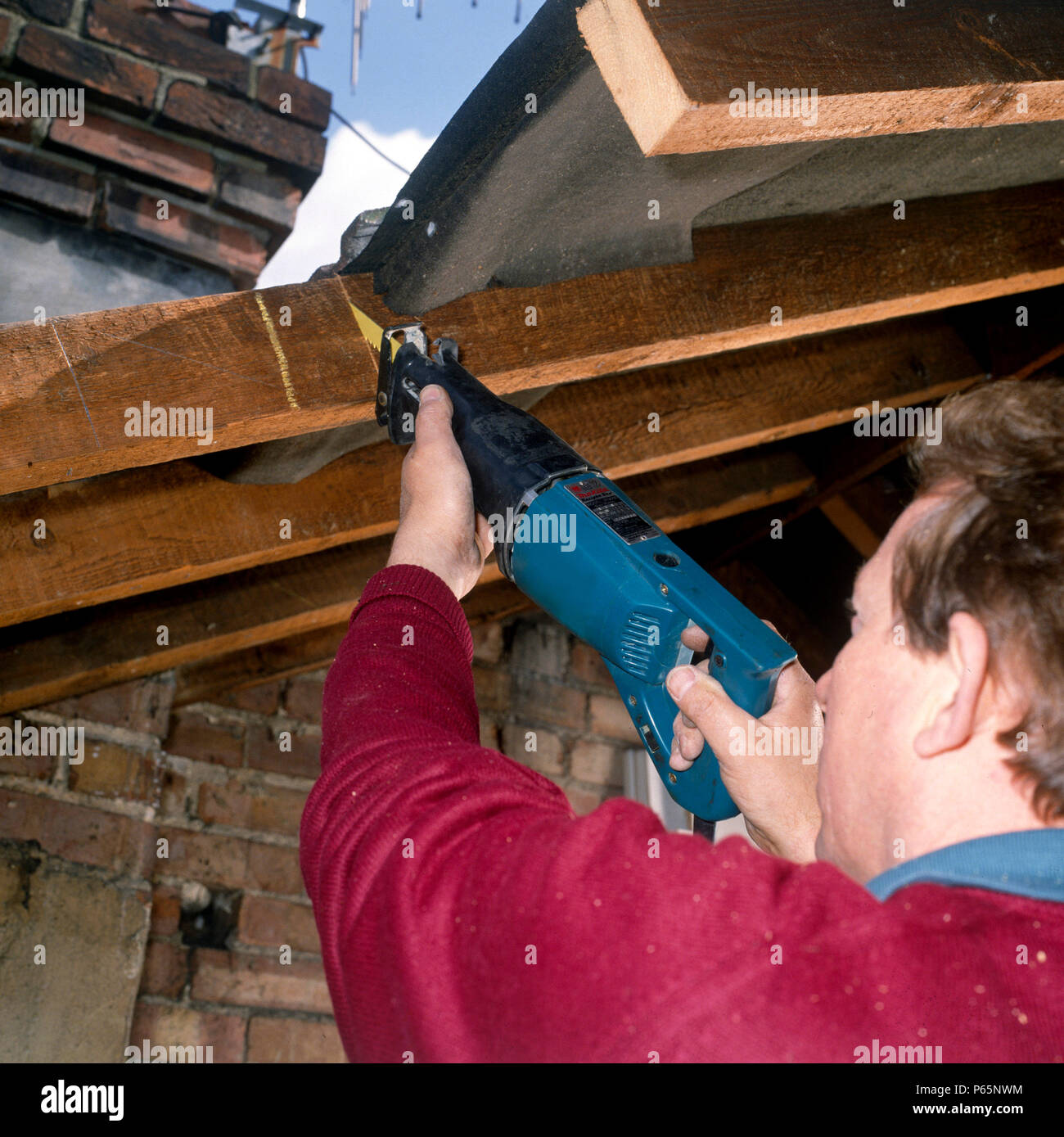 Loft conversion. Installing a new roof window Stock Photo - Alamy