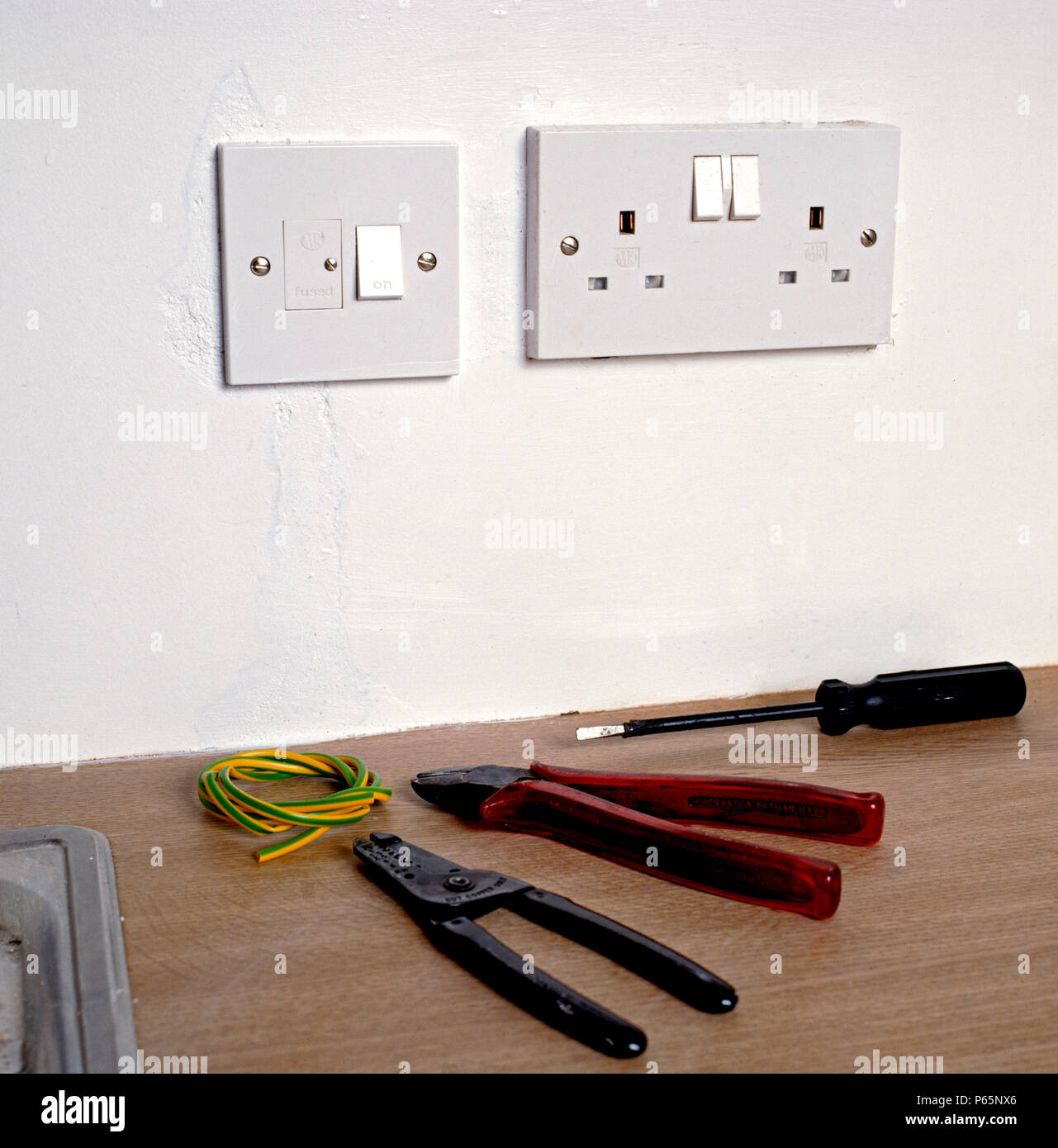 New plug sockets chased into a wall Stock Photo - Alamy
