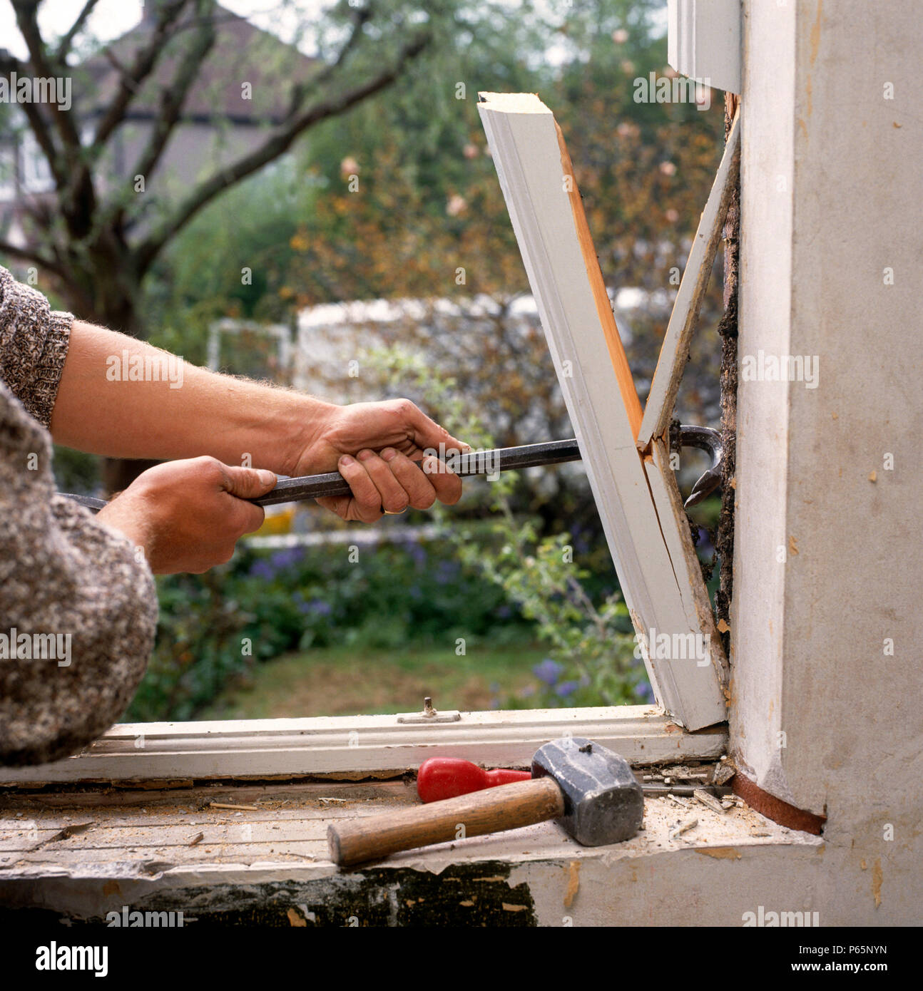 Replacing a damaged window Stock Photo - Alamy