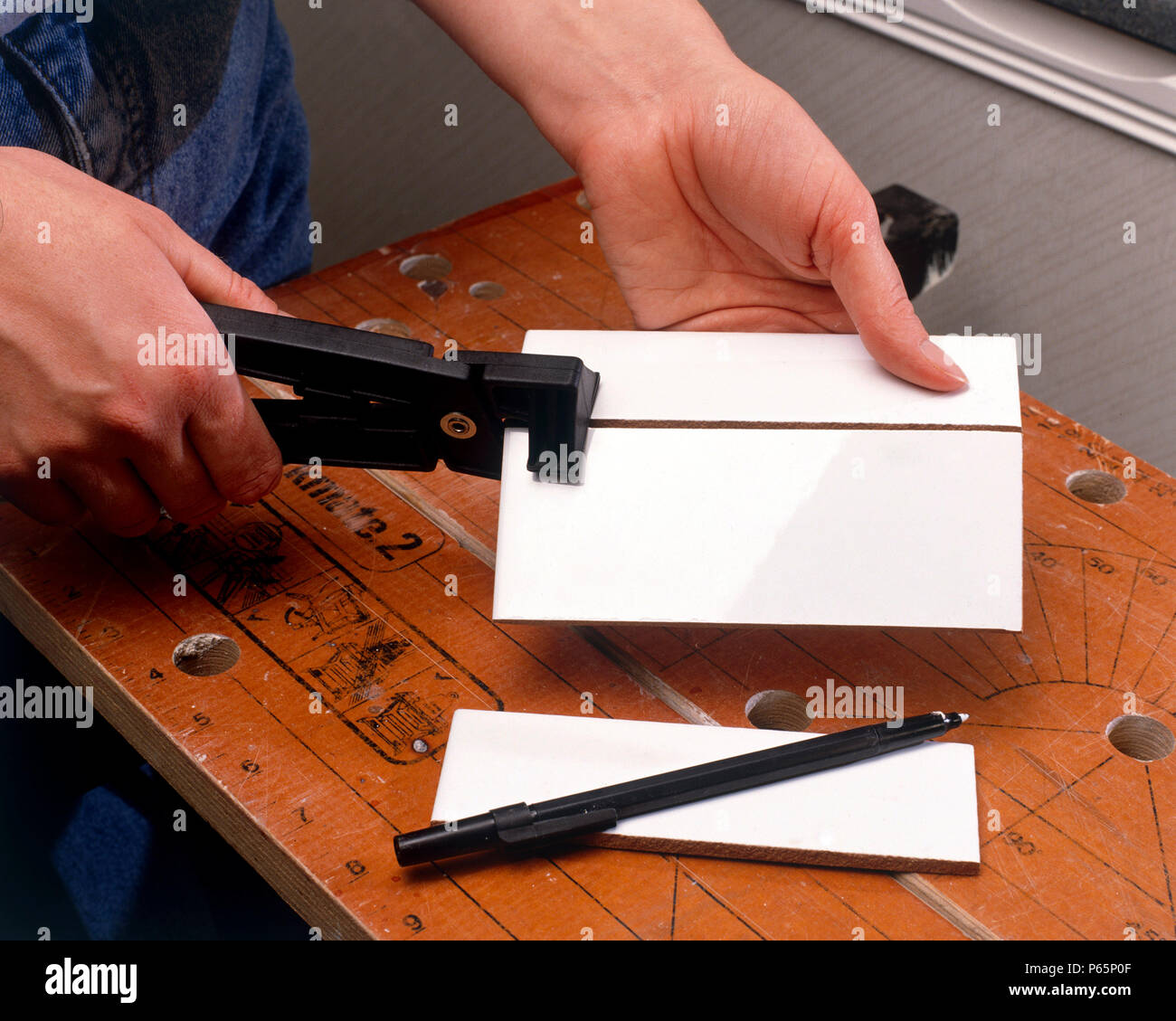 Tiling in progress. Cutting tiles Stock Photo - Alamy