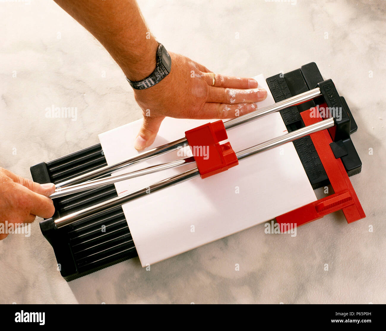 Tiling in progress. Cutting tiles Stock Photo - Alamy