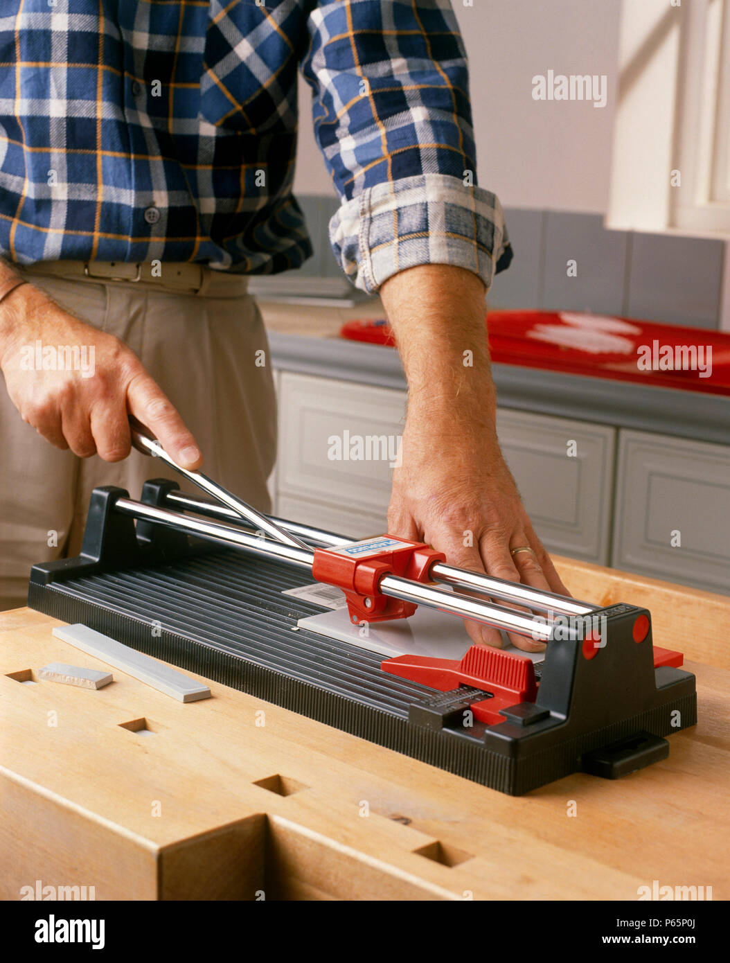 Tiling in progress. Cutting tiles Stock Photo - Alamy