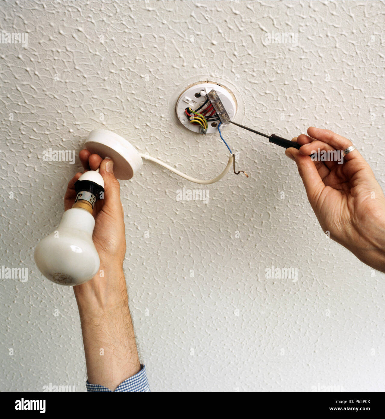 Wiring a lamp on a ceiling Stock Photo - Alamy