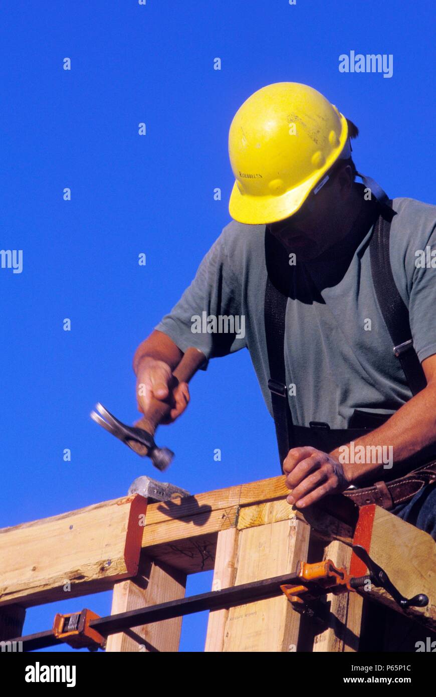 Carpenter nailing wall top plates to join intersecting walls Stock ...
