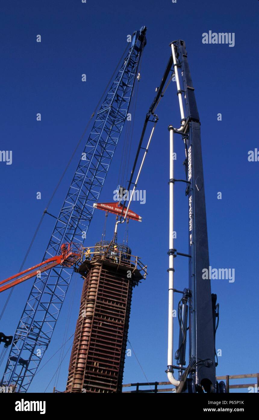 Pouring concrete for column for freeway bridge in California using boom ...