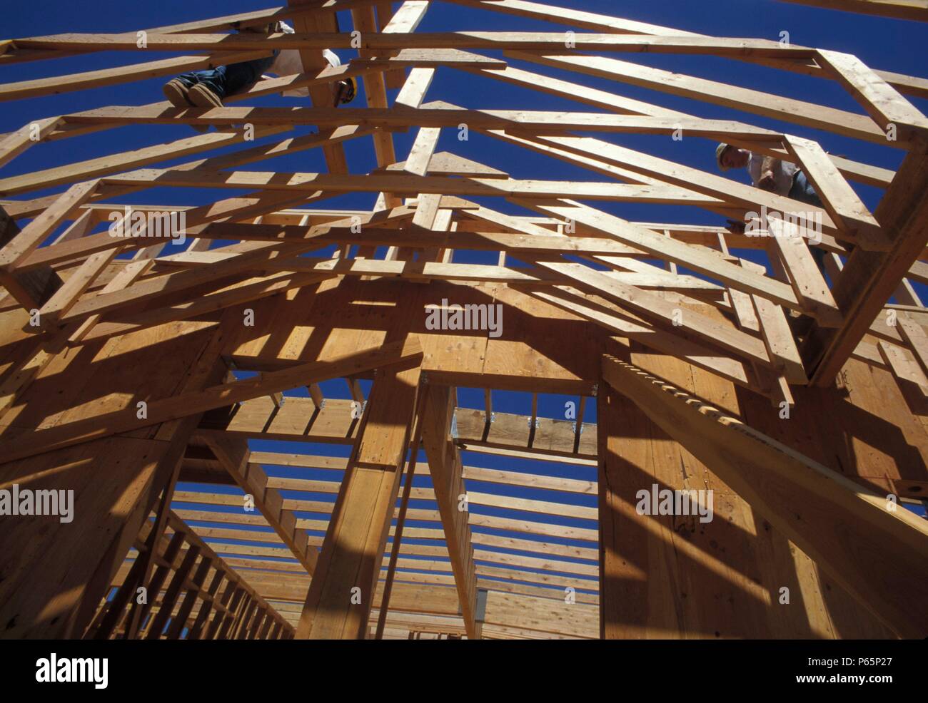 Carpenters instally roof trusses in elementary school building in ...